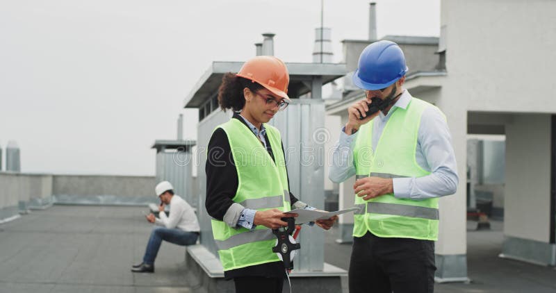 In a Modern Construction Site on the Rooftop Beautiful African Lady ...