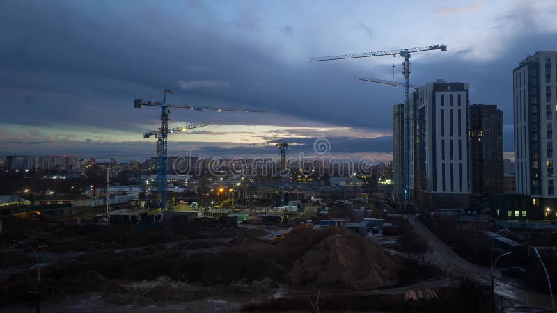 Modern Construction Site with Tower Cranes Working at Dusk in Urban ...
