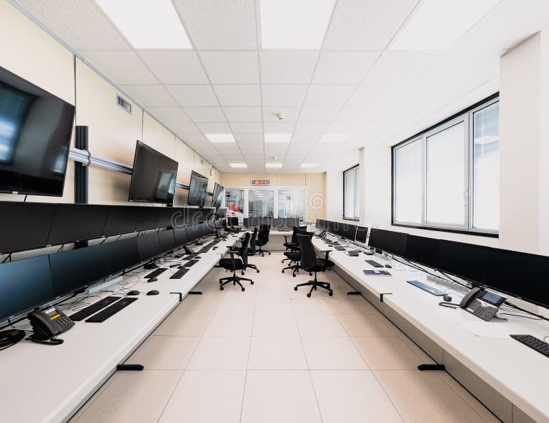 A Modern Control Room with Several Computer Monitors and Desks, and ...