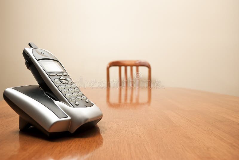 Modern Cordless Phone Sitting on an Empty Table Stock Photo - Image of ...