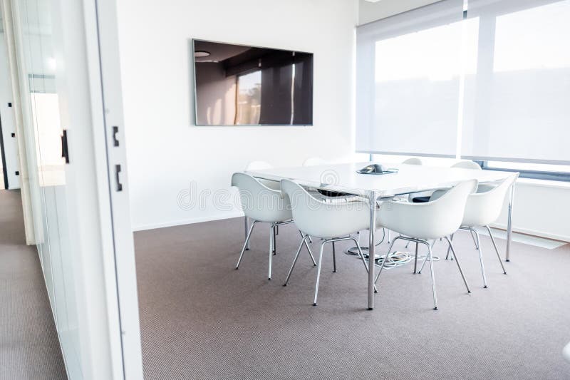 Modern Corporate Conference Room with White Chairs and a Bright ...