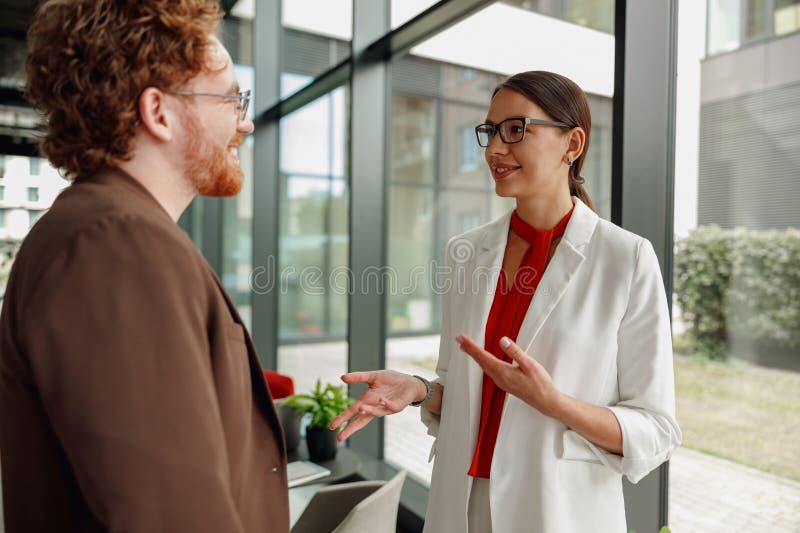 Business Professionals Engaged in Dynamic Conversation within a ...