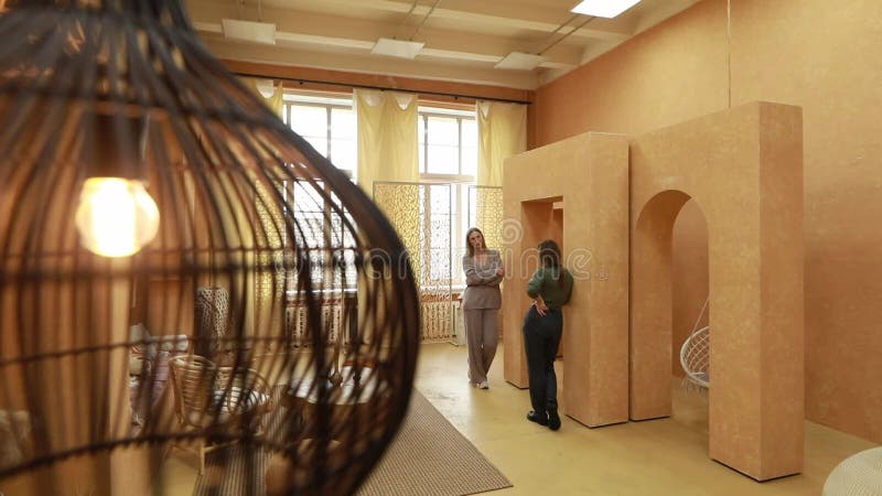 Two Women Discuss Design Ideas in a Modern Creative Studio with Warm ...