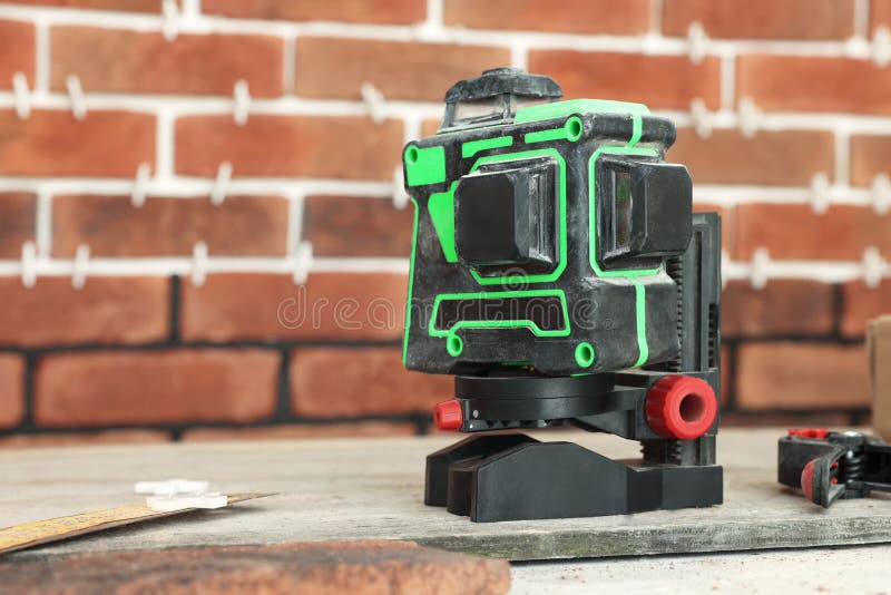 Modern Cross Line Laser Level on Floor Indoors, Space for Tex. Tiles ...