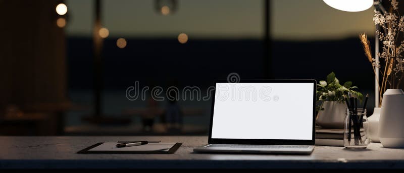 A Modern Dark Office at Night Featuring a White-screen Laptop Computer ...