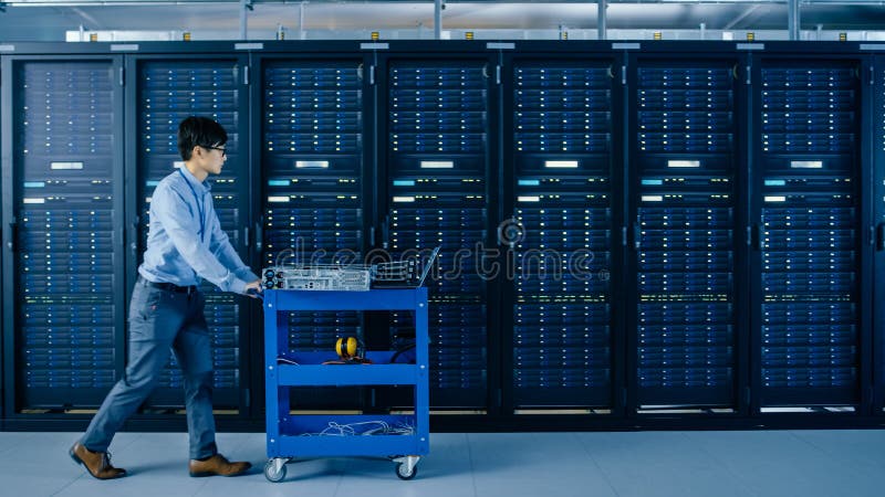 In the Modern Data Center: it Engineer Pushes Cart Alongside Server ...