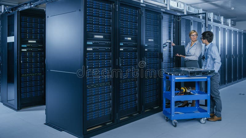 In the Modern Data Center: Engineer and it Specialist Work with Server ...