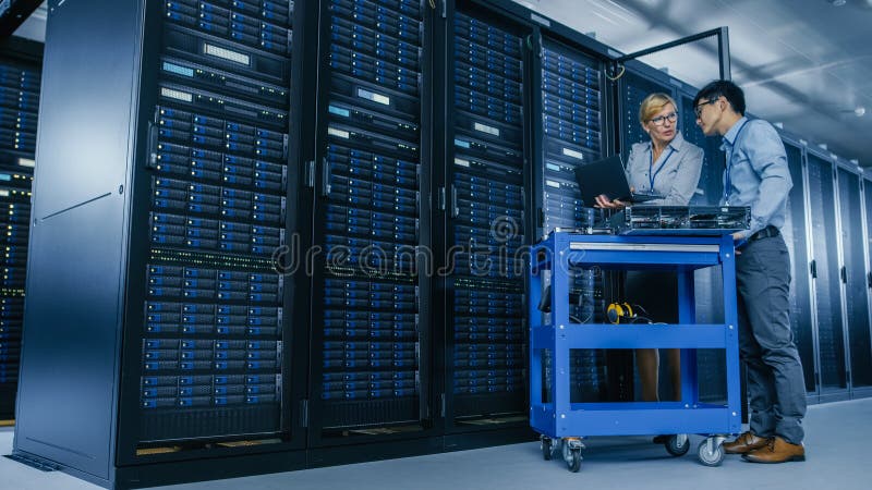 In the Modern Data Center: Engineer and it Specialist Work with Server ...