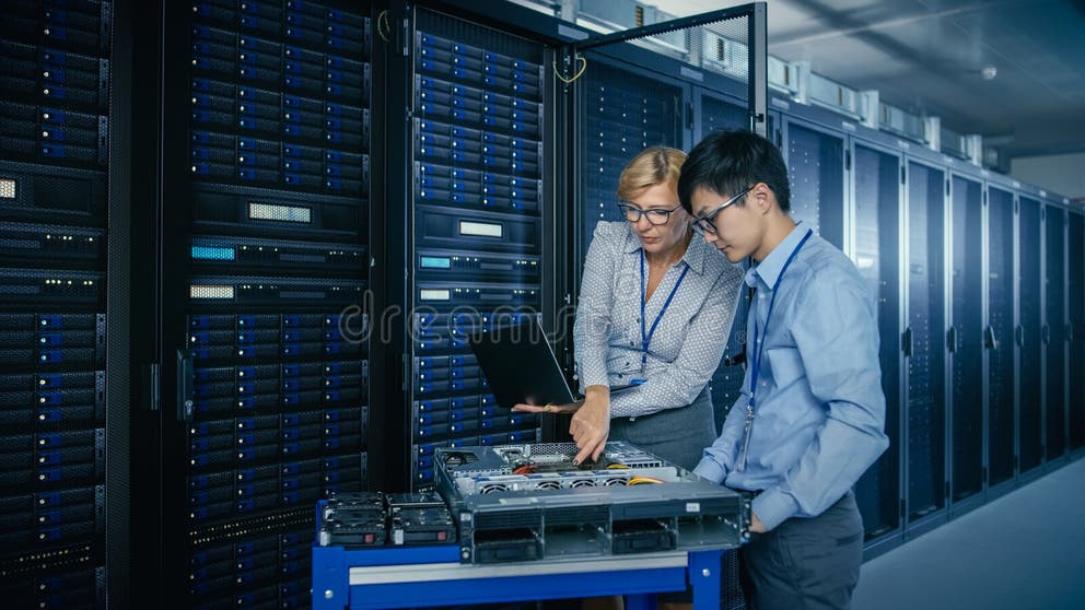 In the Modern Data Center: Engineer and it Specialist Work with Server ...