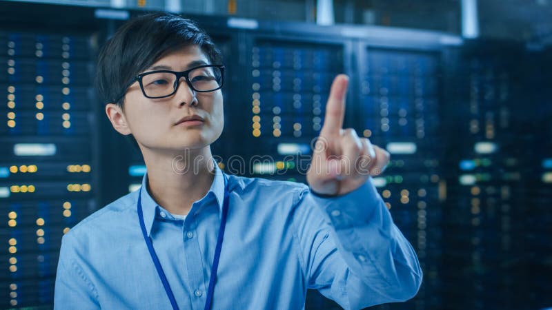 In the Modern Data Center: Portrait of it Engineer Working with Touch ...