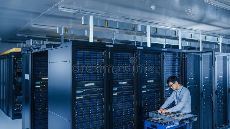 In the Modern Data Center: it Technician Working with Server Racks, on ...