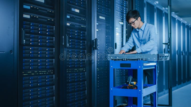 In the Modern Data Center: it Technician Working with Server Racks, on ...