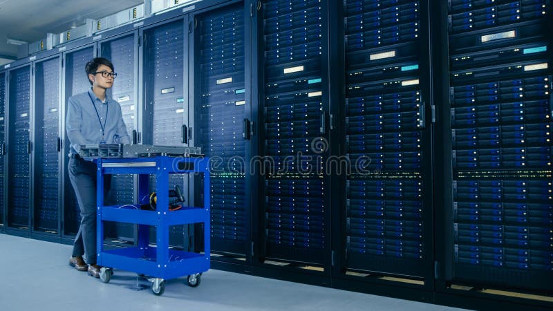 In the Modern Data Center: it Technician Working with Server Racks ...