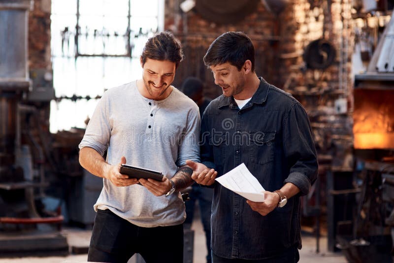 Modern Day Business Requires Modern Day Tools. Two Handsome Young Using ...