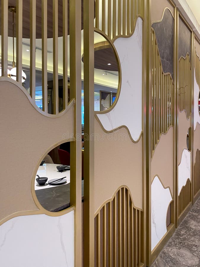A Modern Decorative Partition Wall with a Gold-colored Frame and ...