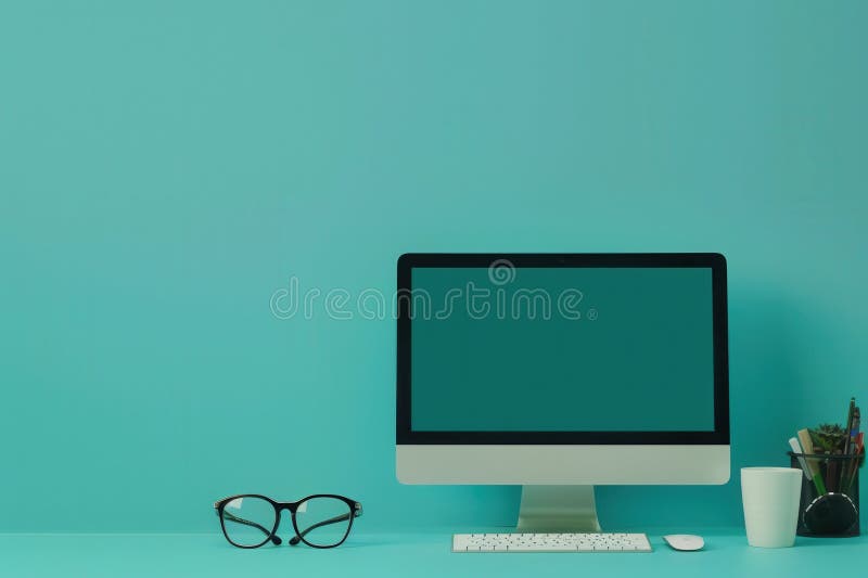 A Modern Desktop Setup with a Computer, Glasses, and a Cup on a ...