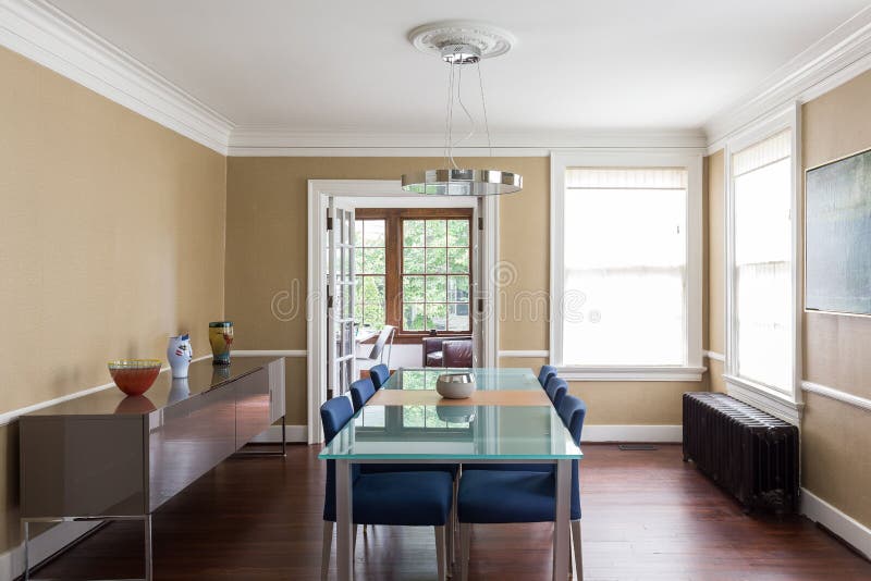 Modern Dining Room in Creme Tones with a Table Surrounded by Blue ...