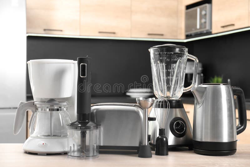 Modern Domestic Appliances on Wooden Table Stock Photo - Image of ...
