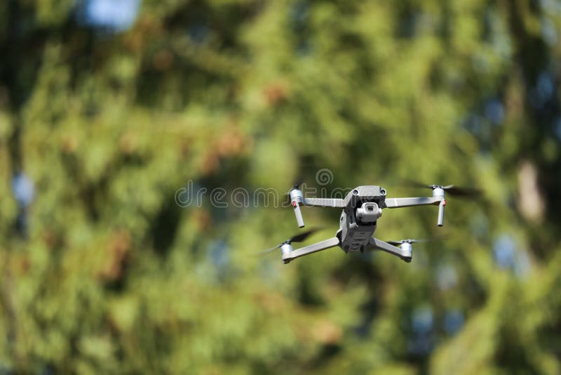 Modern Drone Flying Outdoors on Sunny Day, Space for Text Stock Photo ...