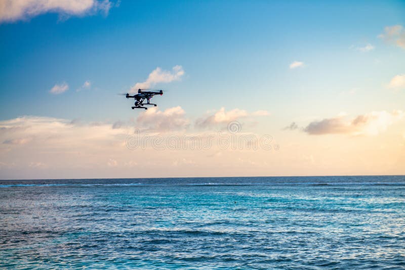 Modern Drone Overflying the Ocean at Sunset Stock Photo - Image of ...