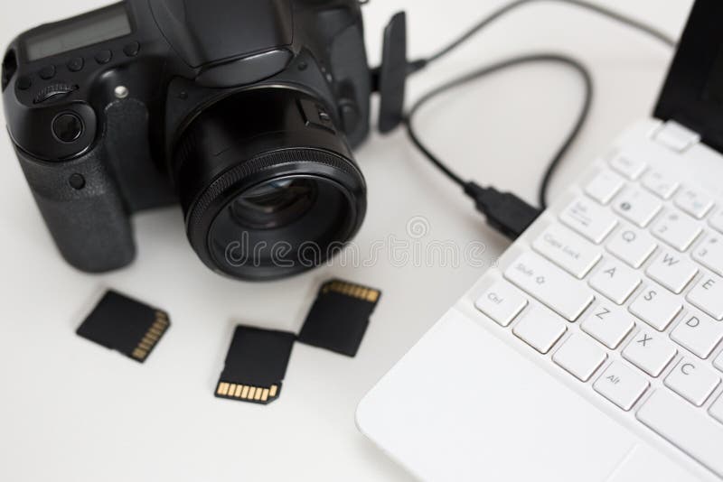 Modern Camera Connected with Computer and Memory Cards on the Ta Stock ...