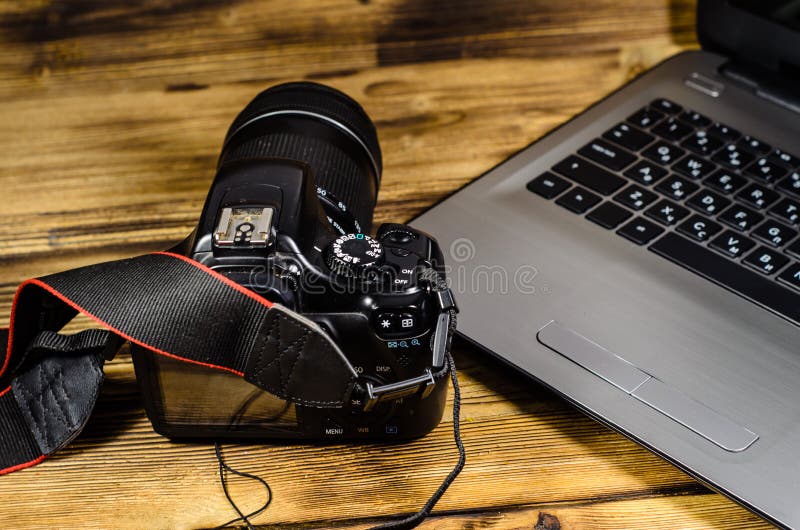 Modern DSLR Camera and Laptop on Wooden Table Stock Image - Image of ...