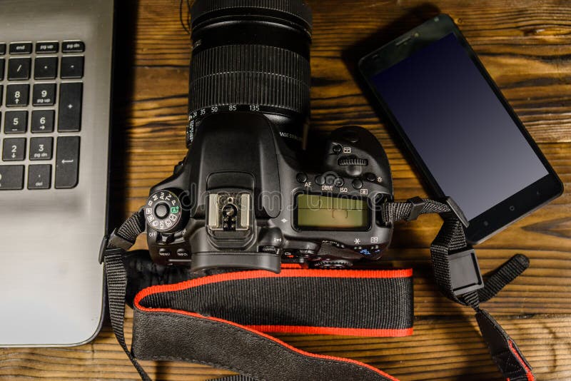 Modern DSLR Camera, Smartphone and Laptop on Wooden Table. Top View ...