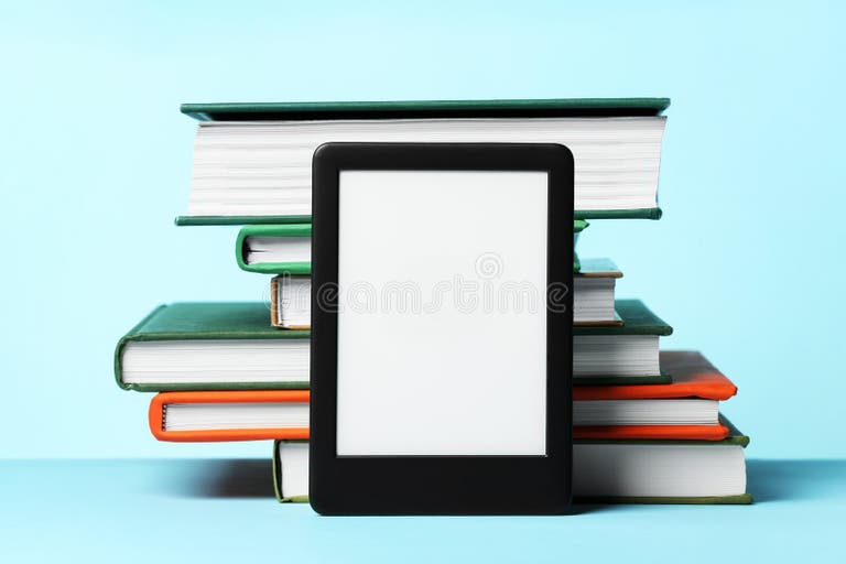 Modern E-book Reader and Stack of Hard Cover Books on Light Blue ...