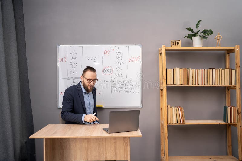 Portrait of Friendly Man Writing on Blackboard English Rules. Education ...