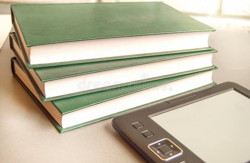 Modern Educational Technologies, E-book Next To a Stack of Books, the ...