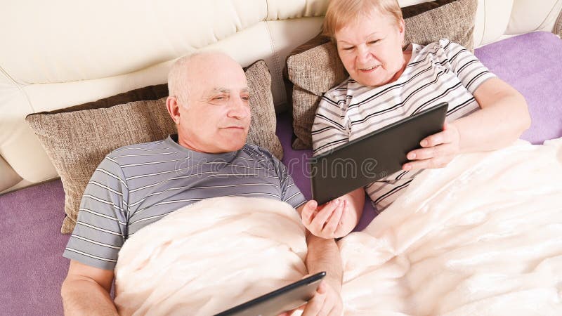 Modern Elderly Couple in Bed Stock Image - Image of communication, male ...