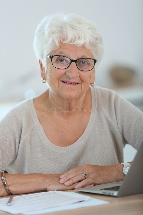 Modern Elderly Woman Using Laptop Stock Image - Image of document ...