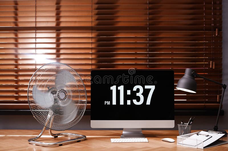 Modern Electric Fan and Computer on Table in Office Stock Image - Image ...