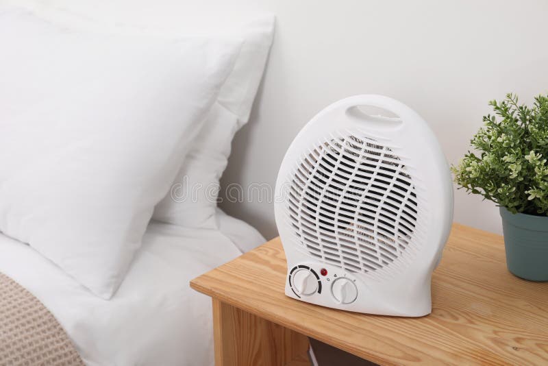 Modern Electric Fan Heater on Bedside Table Indoors Stock Photo - Image ...
