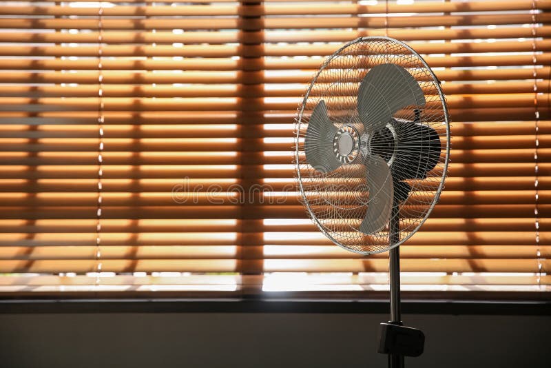 Modern Electric Fan Near Window Indoors. Space for Text Stock Image ...
