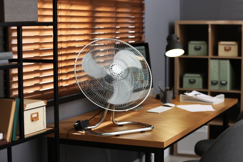 Modern Electric Fan on Table in Office Stock Photo - Image of office ...