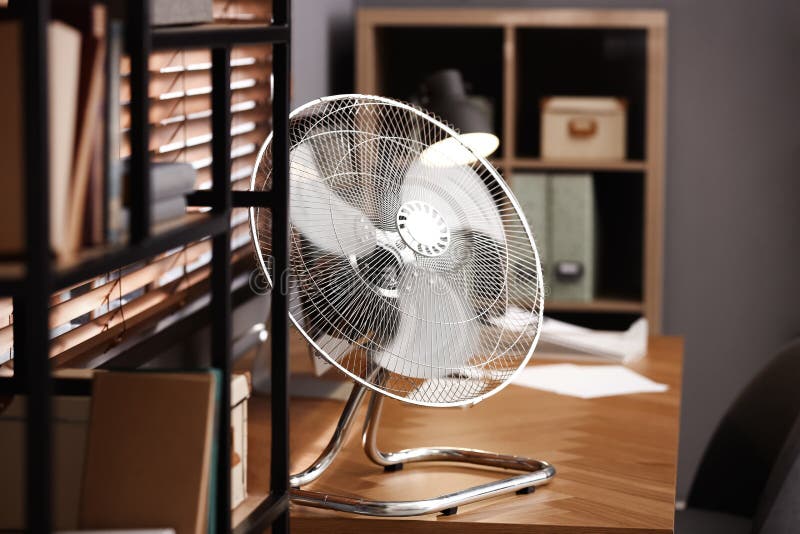 Modern Electric Fan on Table in Office Stock Image - Image of office ...