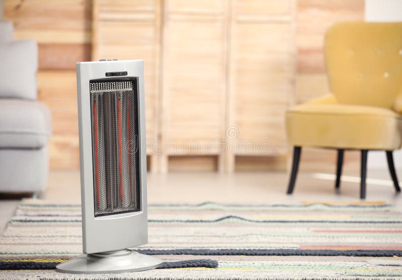 Modern Electric Infrared Heater on Floor at Home Stock Photo - Image of ...