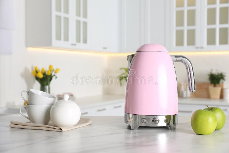 Electric Kettle, Tea Set and Apples on Table in Kitchen Stock Image ...