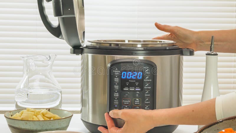Modern Electric Multi Cooker Close Up on Kitchen Table. Woman Pushing ...
