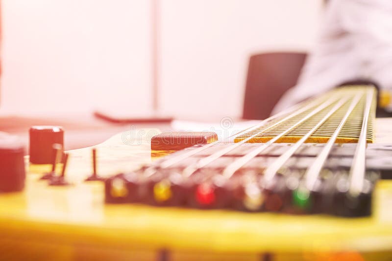 Modern Electric Six-string Bass Guitar on a Stand in Rehearsal Room ...