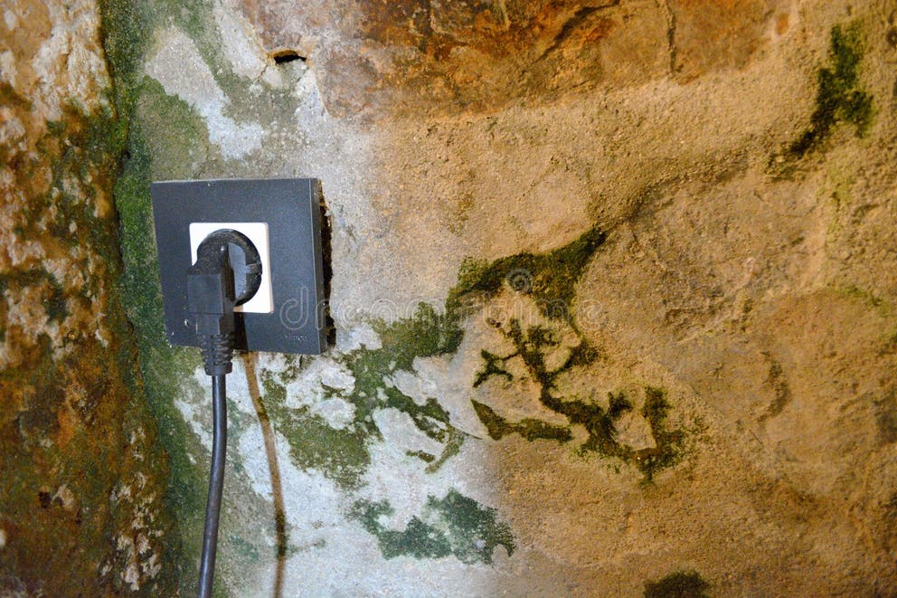 A Modern Electrical Outlet with Plug is Embedded in an Antique Stone ...