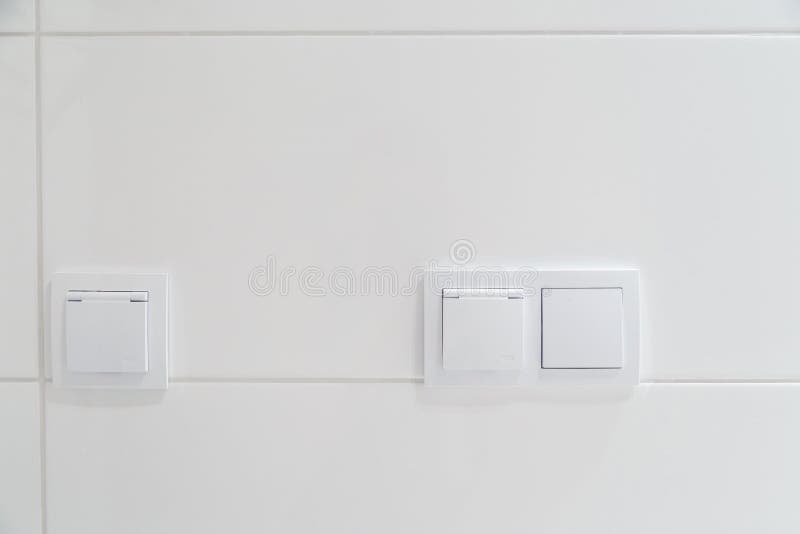Modern Electrical Switches on a White Wall of Tiles Stock Photo - Image ...