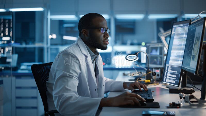Modern Electronics Development Facility: Male Engineer Works on Computer with CAD Programming ...