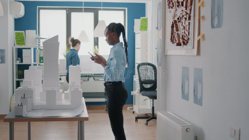 Modern Engineer Using Mobile Phone To Design Construction Layout with ...