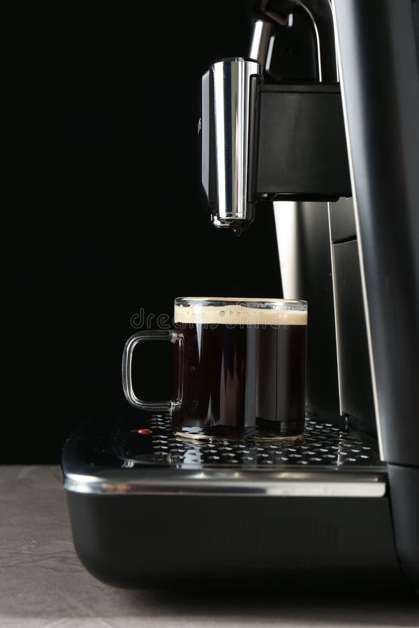 Modern Espresso Machine with Glass Cup of Coffee on Grey Table Against ...