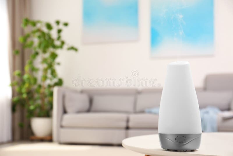 Modern Essential Oil Diffuser on Table in Room Stock Image - Image of ...