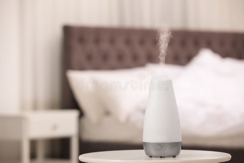 Modern Essential Oil Diffuser on Table. Space for Text Stock Photo ...