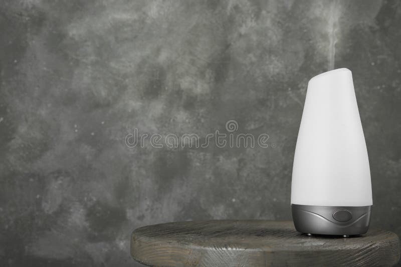 Modern Essential Oil Diffuser on Wooden Table Against Grey Background ...