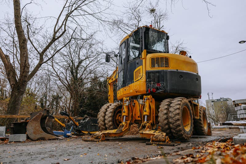 Modern Excavator with a Blade and Pipe at a Construction Site on an ...
